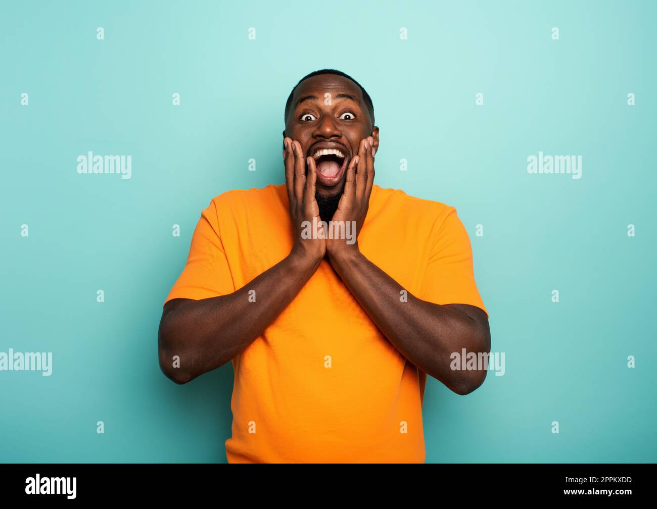 Amazed and shocked expression of a boy over cyan background Stock Photo ...
