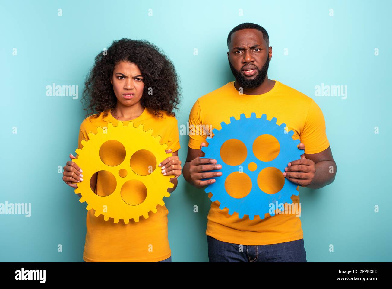 Couple with gears over light blue background. Concept of integration ...