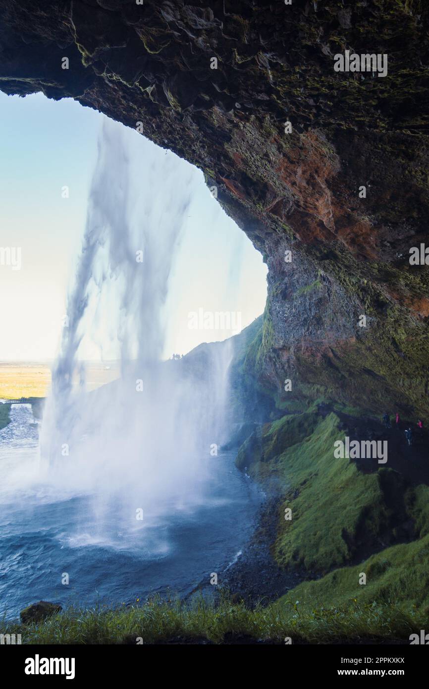 Cave under wonderful waterfall landscape photo Stock Photo - Alamy