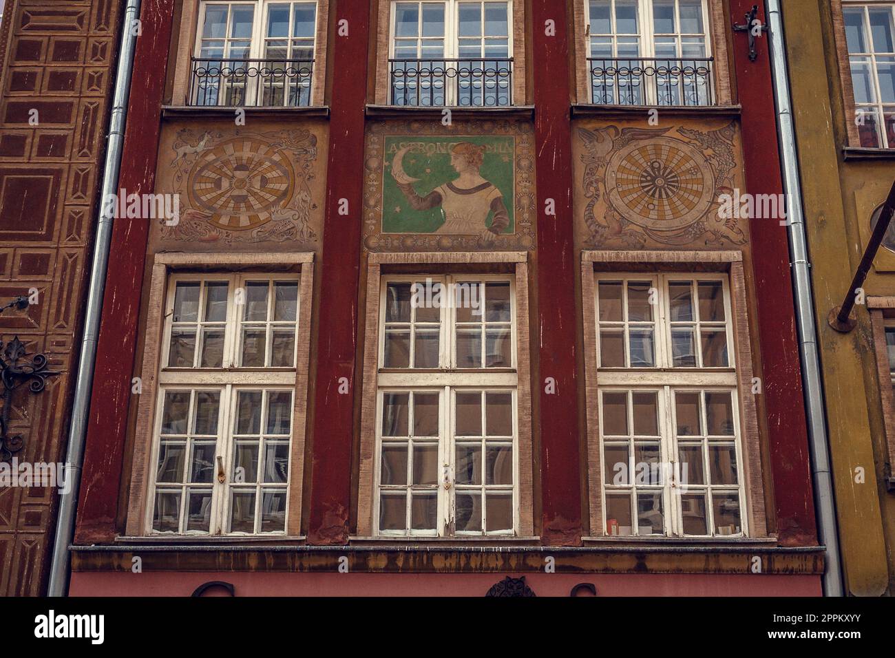 Antique pictures and decor around building windows exterior photo Stock ...