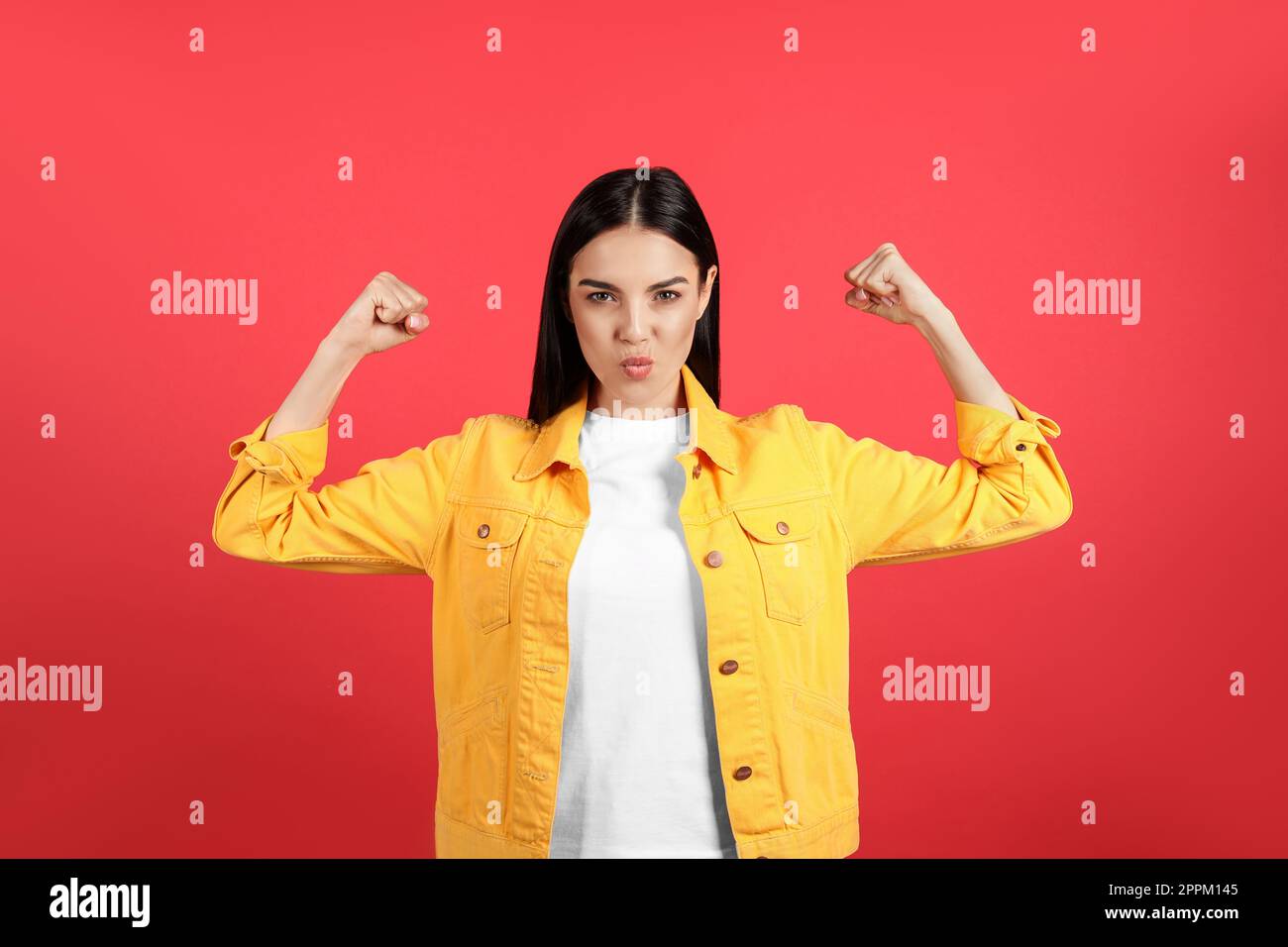 Strong woman as symbol of girl power on red background. 8 March concept ...