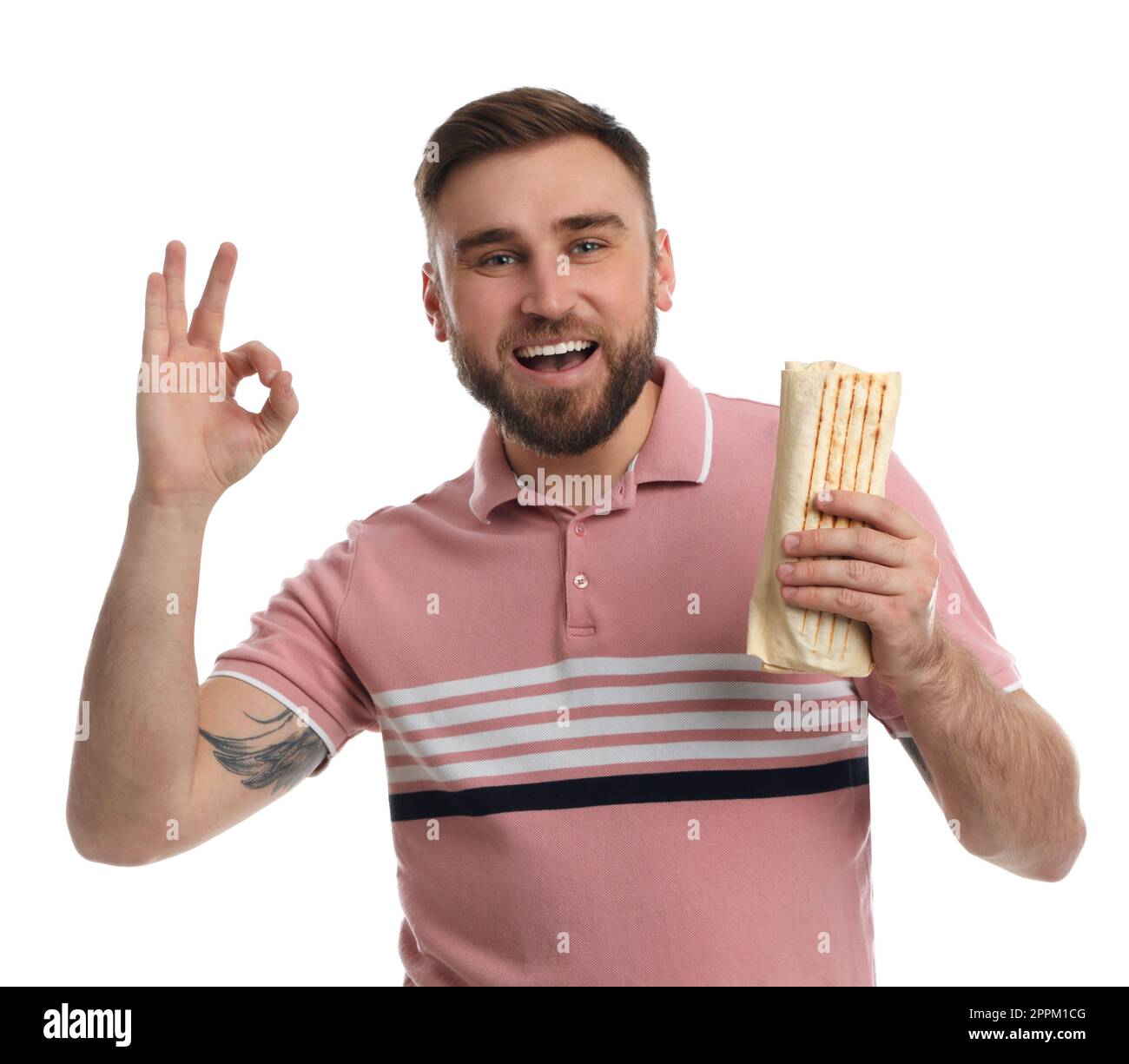 Young man with delicious shawarma on white background Stock Photo - Alamy