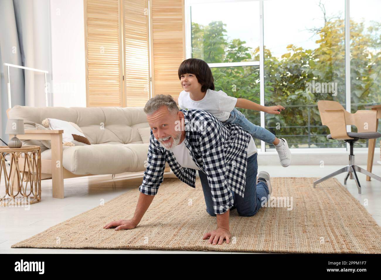 Happy grandfather with his grandson playing together at home Stock ...