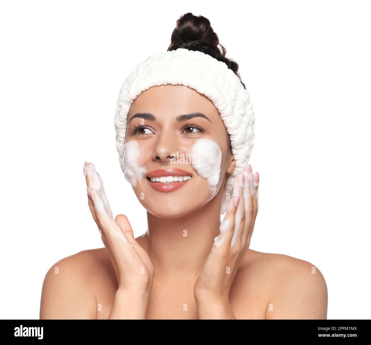Beautiful woman applying facial cleansing foam on white background ...