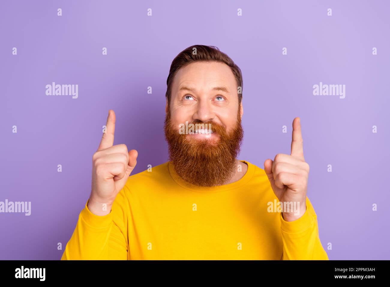 Photo of young smiling promoter guy red beard brutal person look point ...