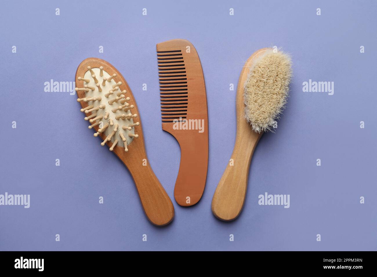 Bamboo brushes and comb on lavender background, flat lay. Conscious ...