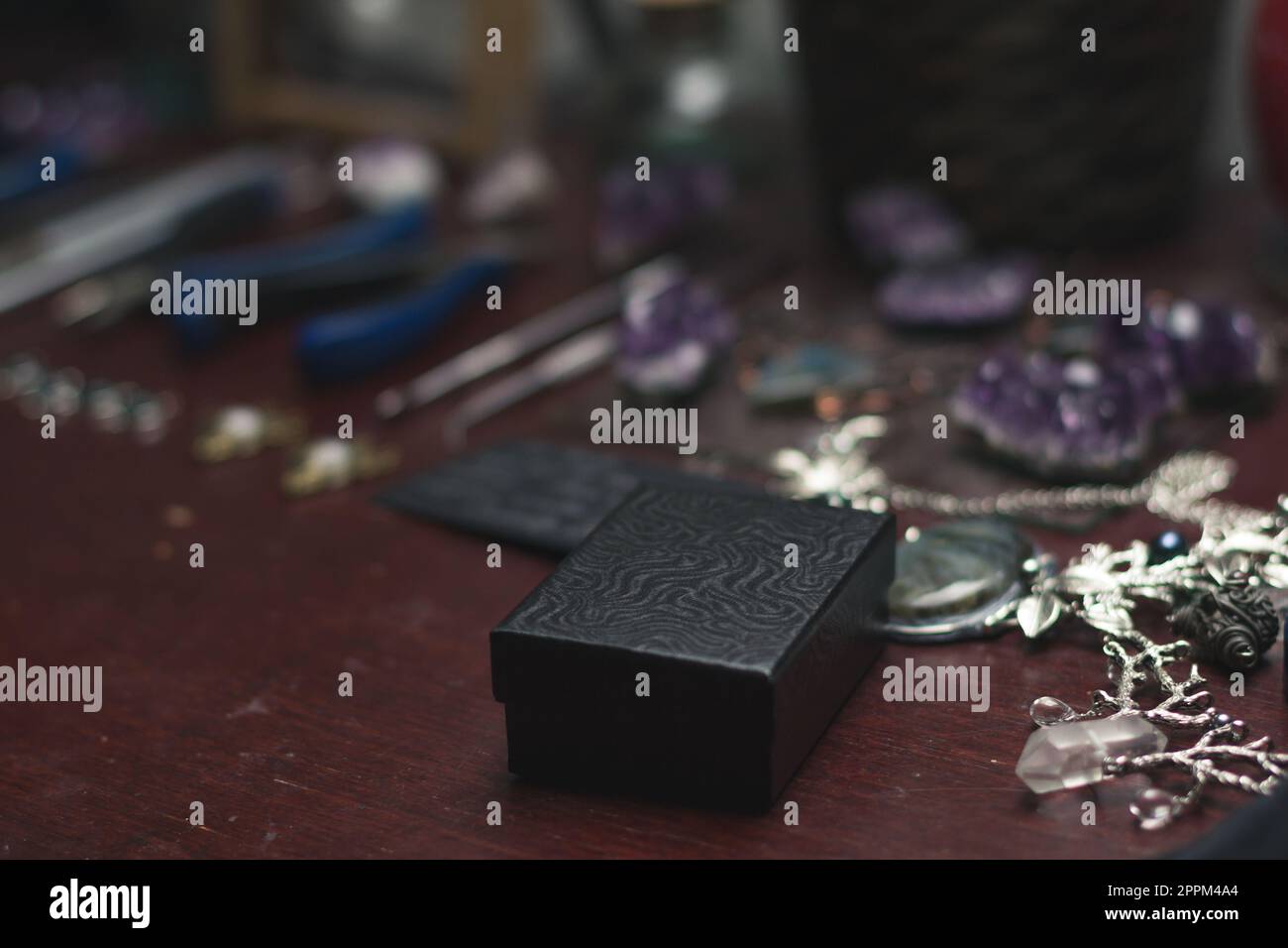 Close up packaging handmade jewelry in custom dark box concept photo ...