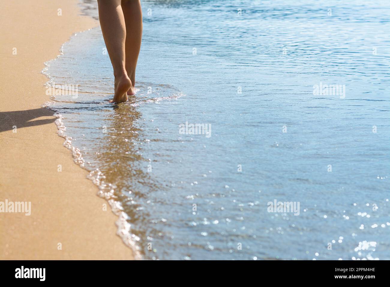 Woman walking by water hi-res stock photography and images - Alamy