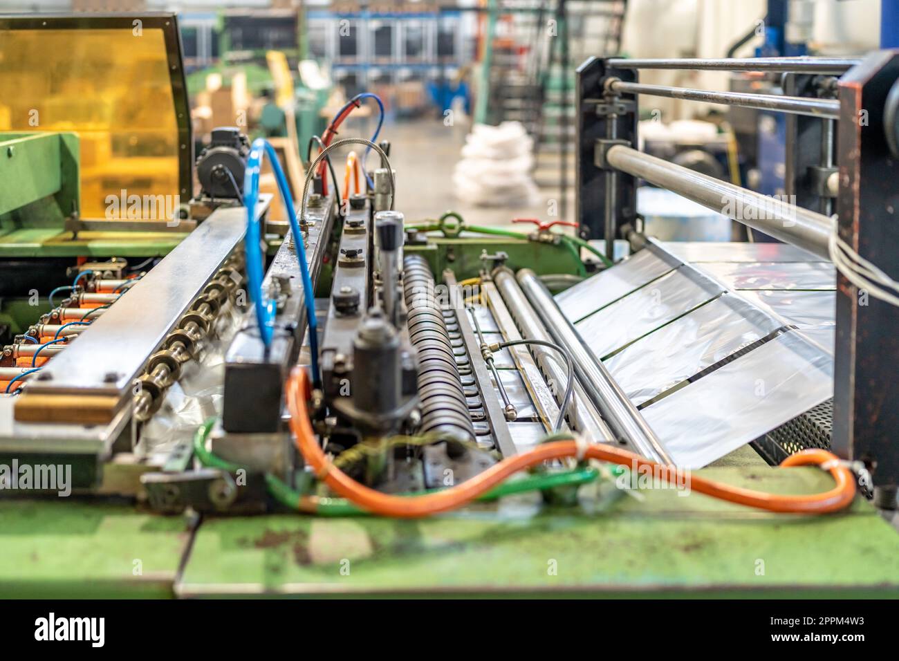 machine for adjusting and dosing plastic packaging for distribution Stock Photo - Alamy