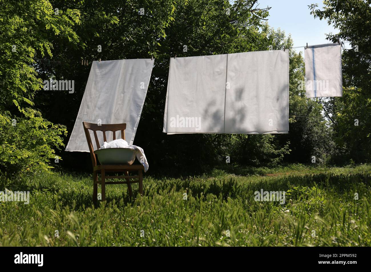 Washing line with clean laundry and clothespins outdoors Stock Photo ...