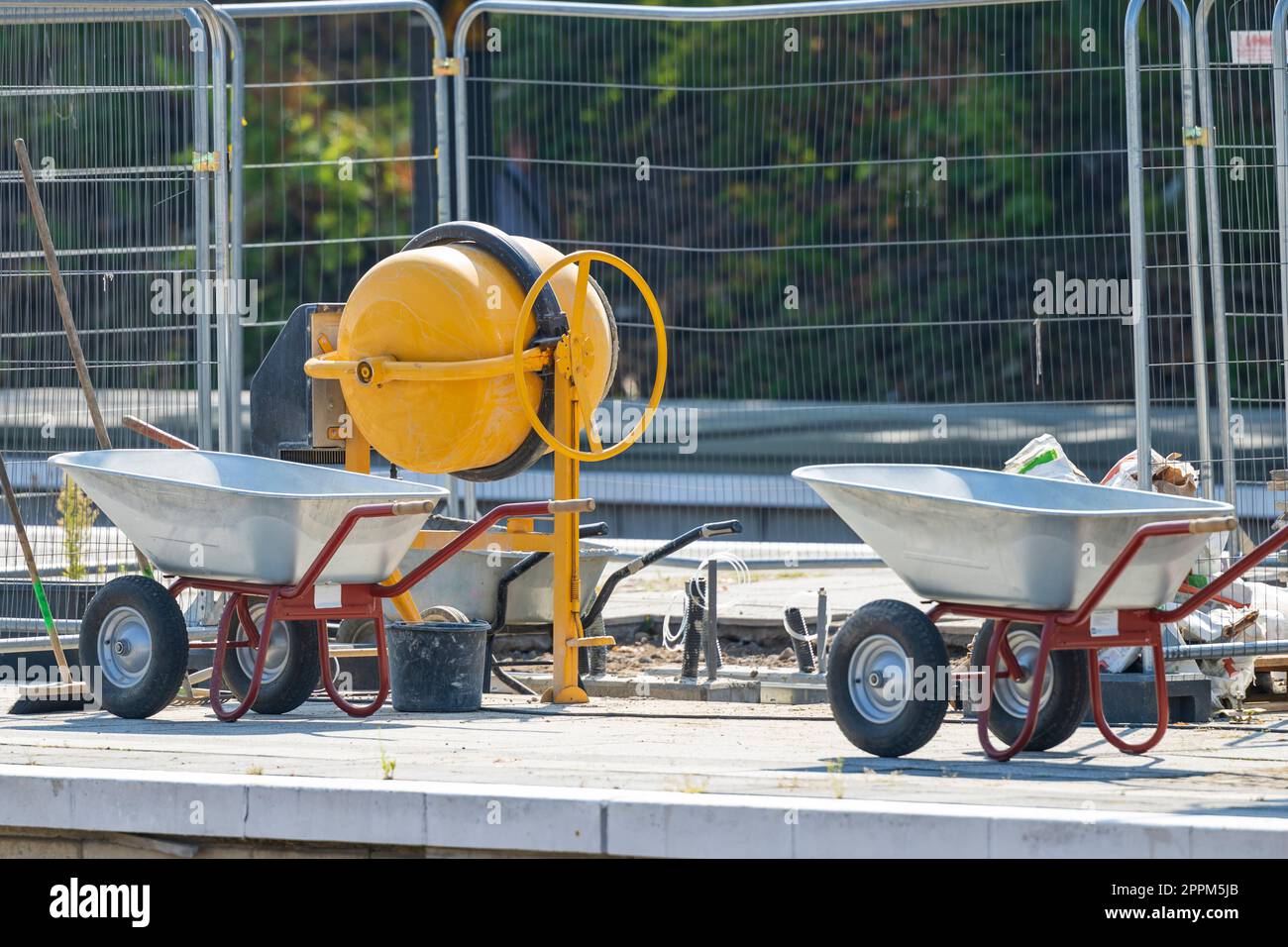 A concrete mixer and wheelbarrow Stock Photo - Alamy