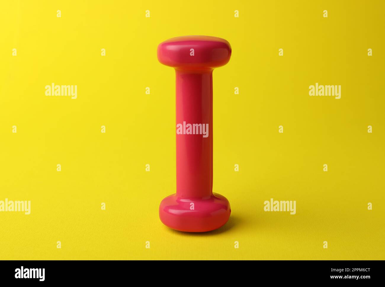 Stylish dumbbell on yellow hi-res stock photography and images - Alamy