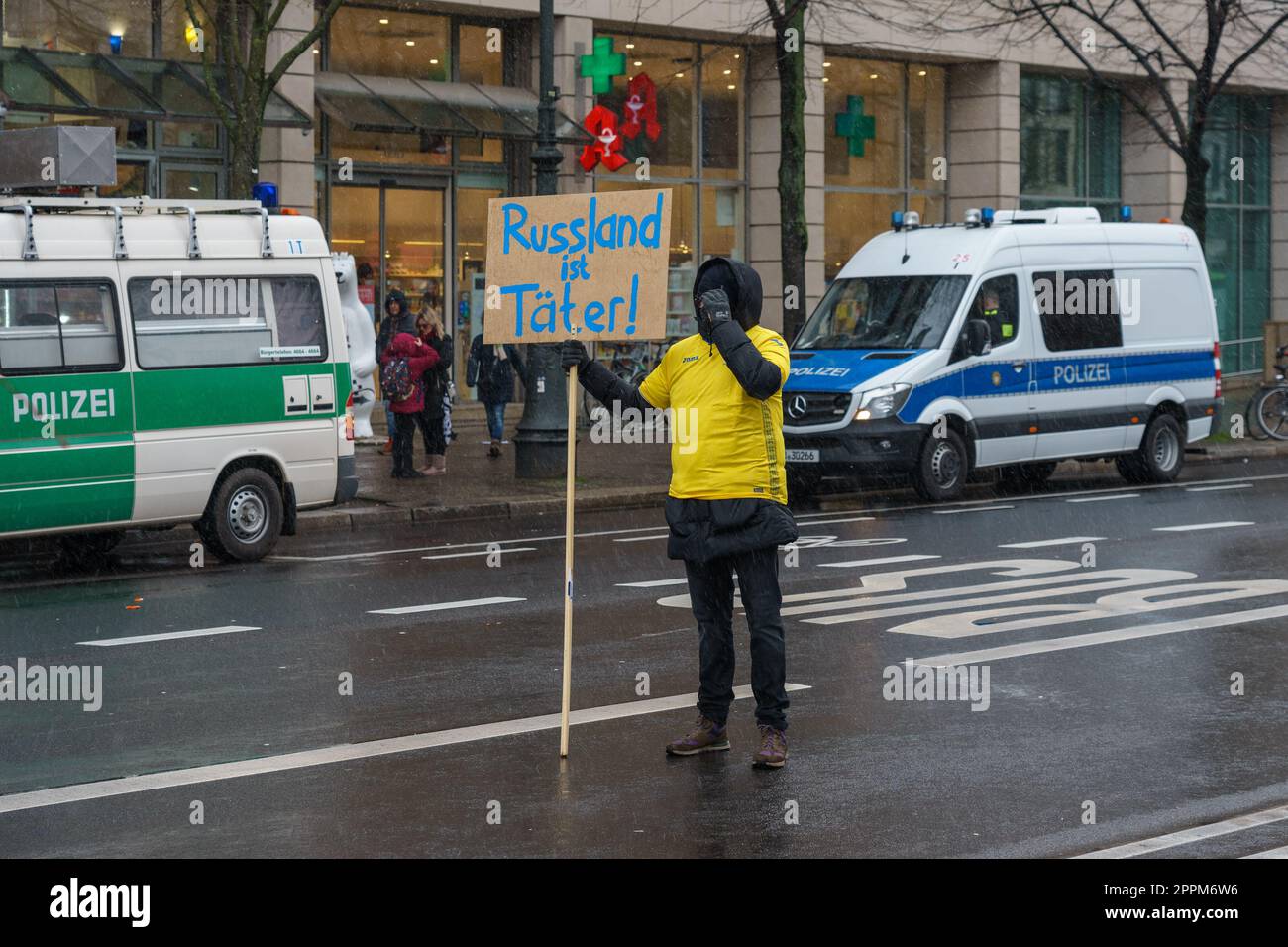 BERLIN - FEBRUARY 25, 2023: Ukrainian activist with a poster in German ...
