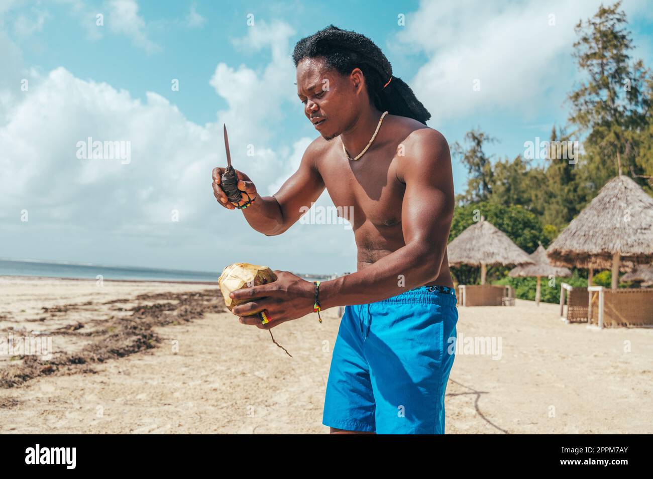 Kenyan people with coconut at the beach with typical local clothes ...