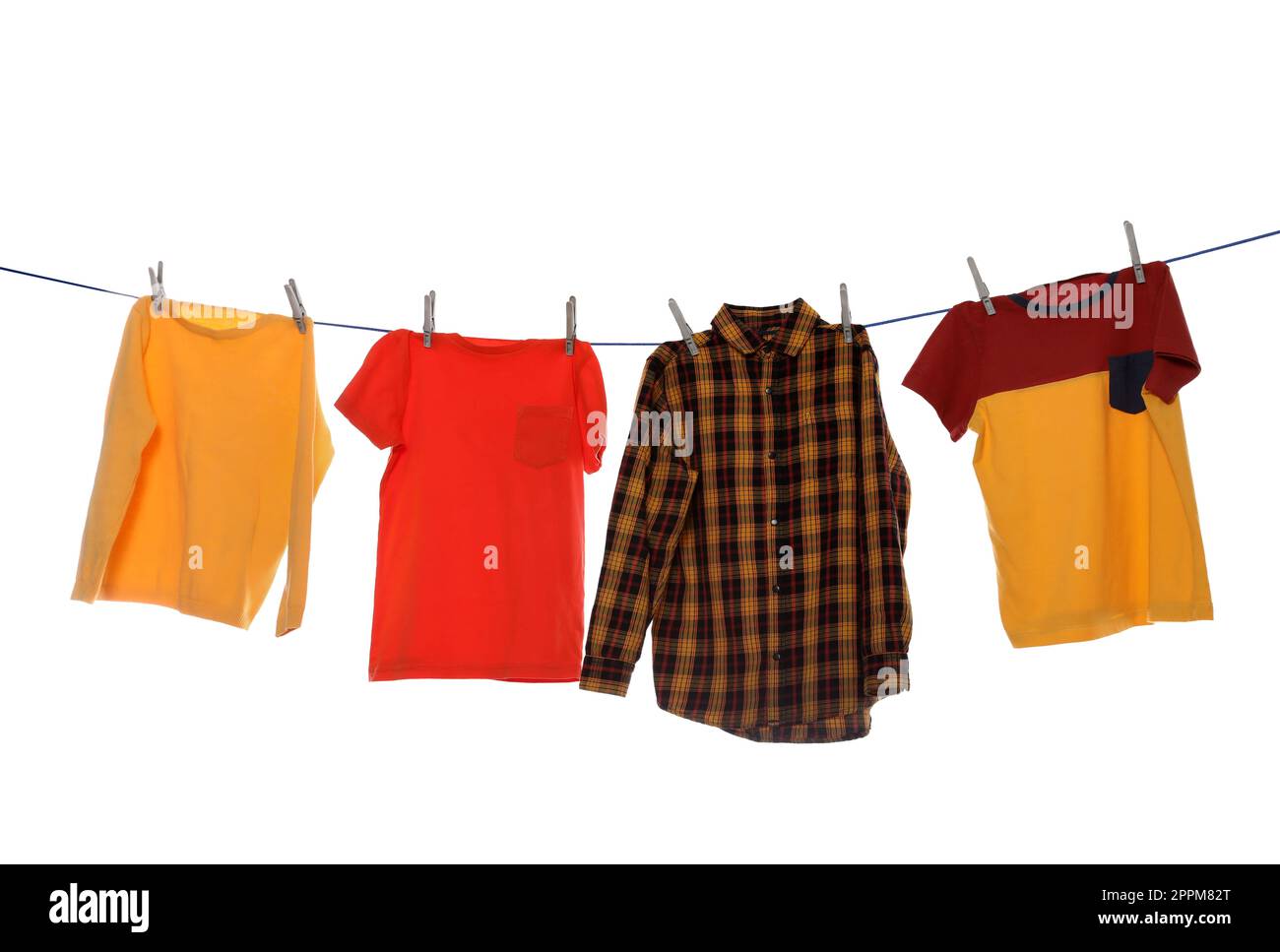 Different bright clothes drying on washing line against white ...