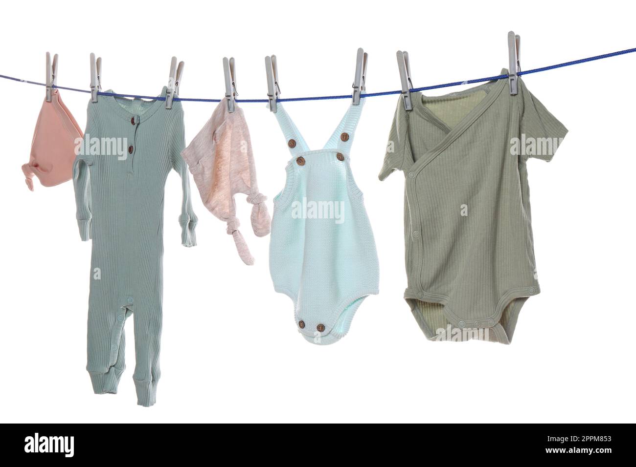 Colorful baby clothes drying on laundry line against white background ...