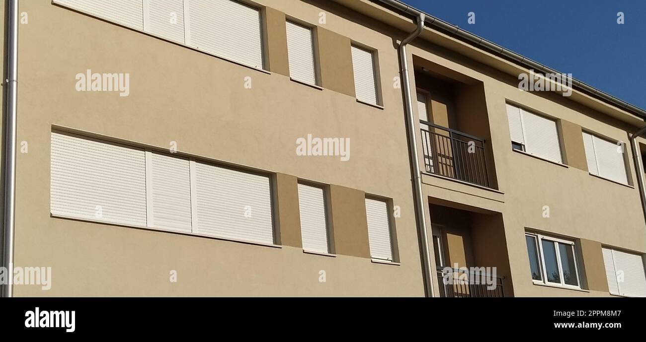 Facade of a new residential building. Modern buildings. Plaster beige ...