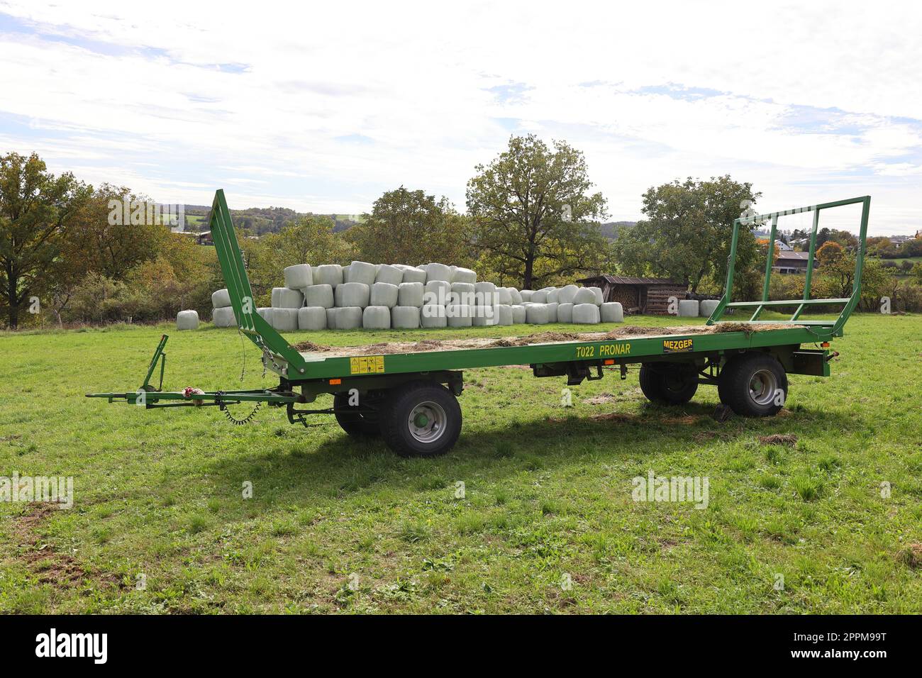 Trailer for transporting hay bales in a meadow Stock Photo - Alamy