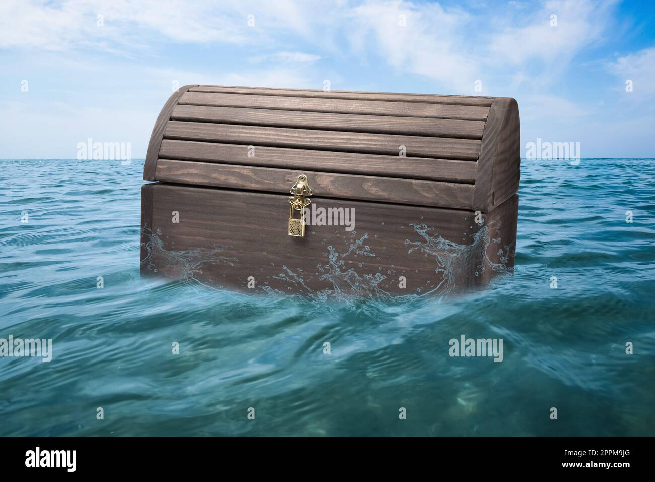 Closed wooden treasure chest floating in sea Stock Photo - Alamy