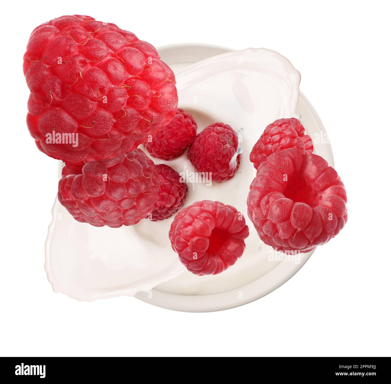 Delicious ripe raspberries falling into bowl with yogurt on white ...