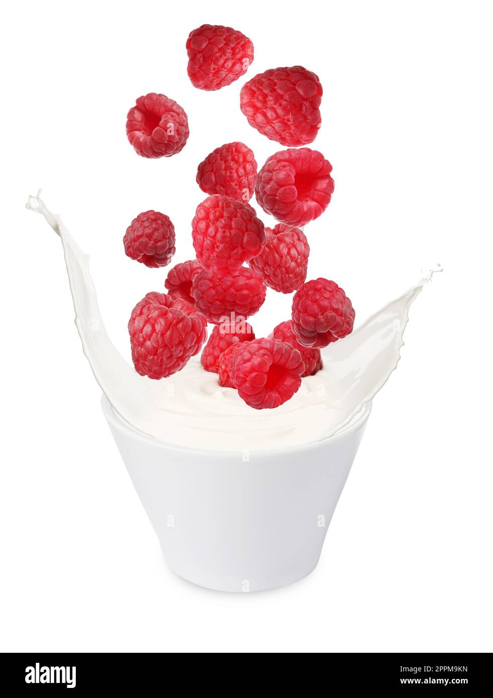 Delicious ripe raspberries falling into bowl with yogurt on white ...