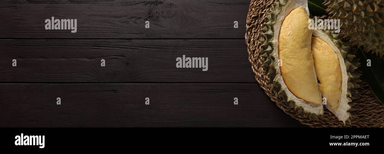 Fresh ripe durians on wooden table, top view with space for text ...