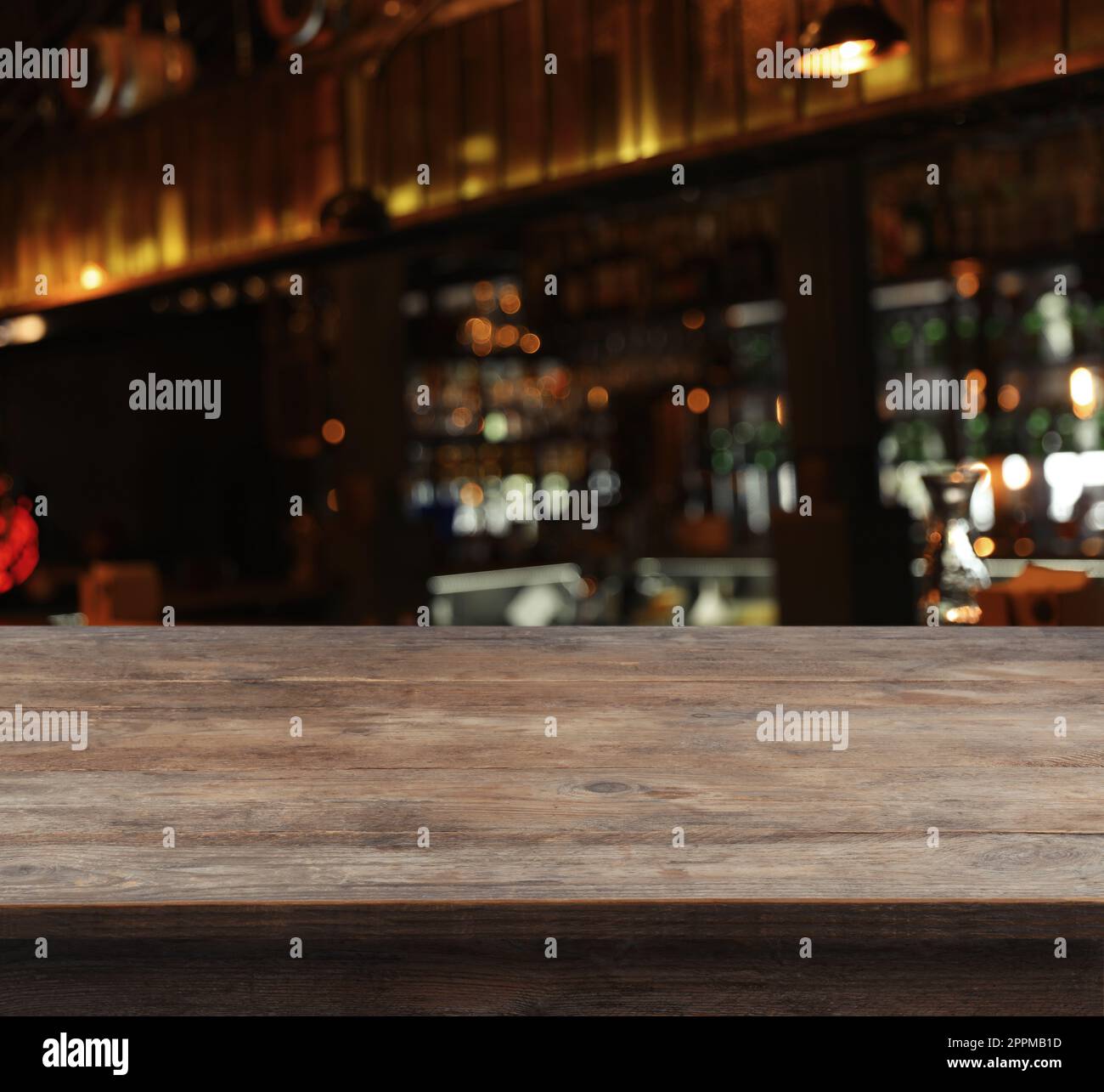 Empty wooden surface and blurred view of bar interior. Space for design ...