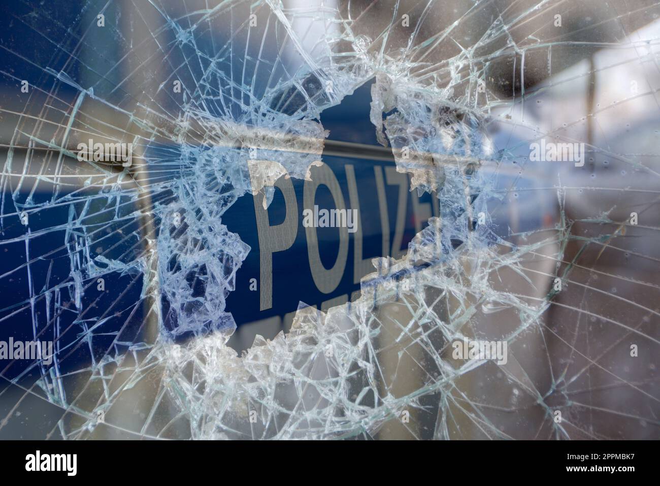 Broken glass and a police car as a symbol of violence against the ...