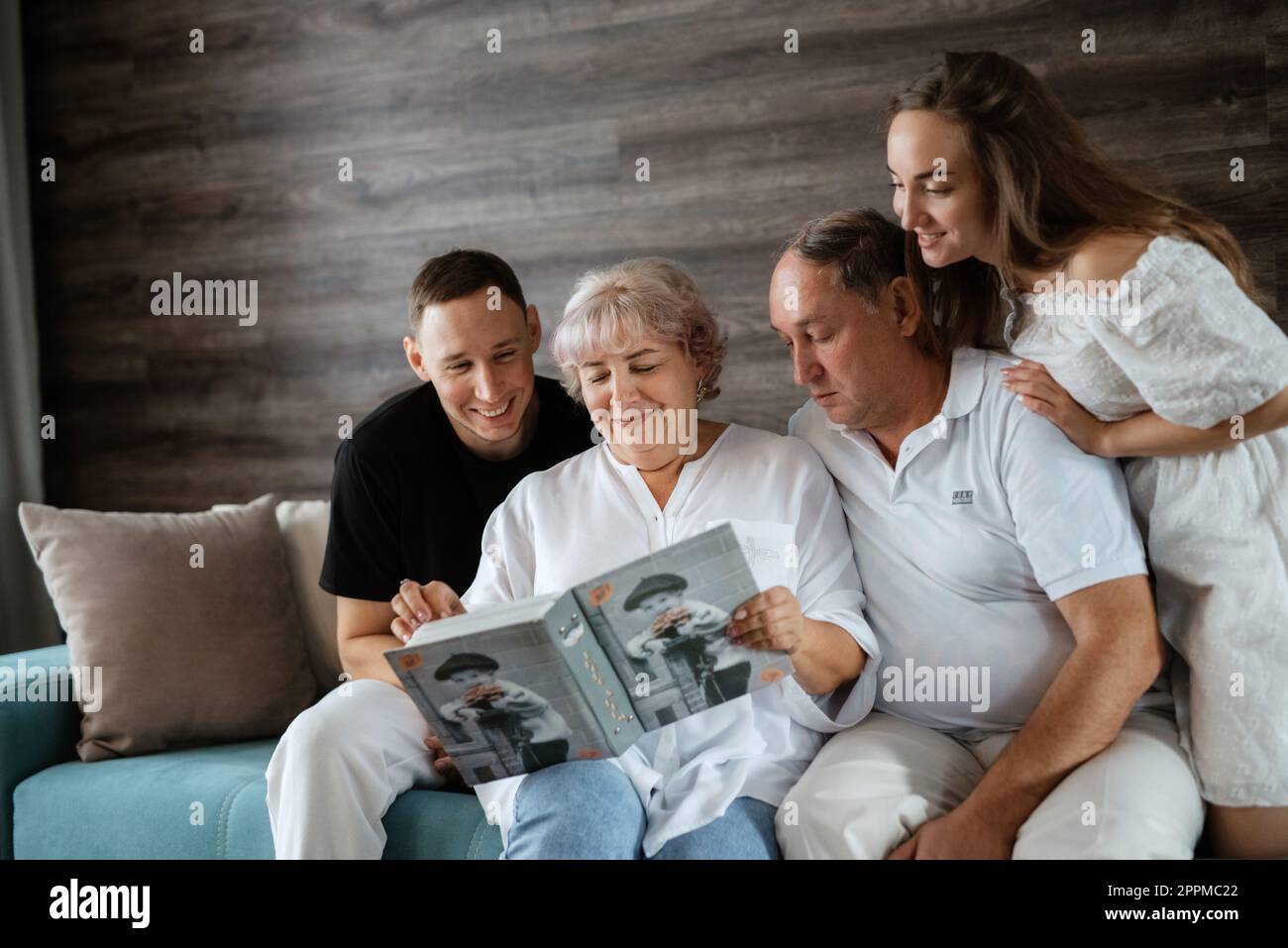 family looking at family photo album Stock Photo - Alamy