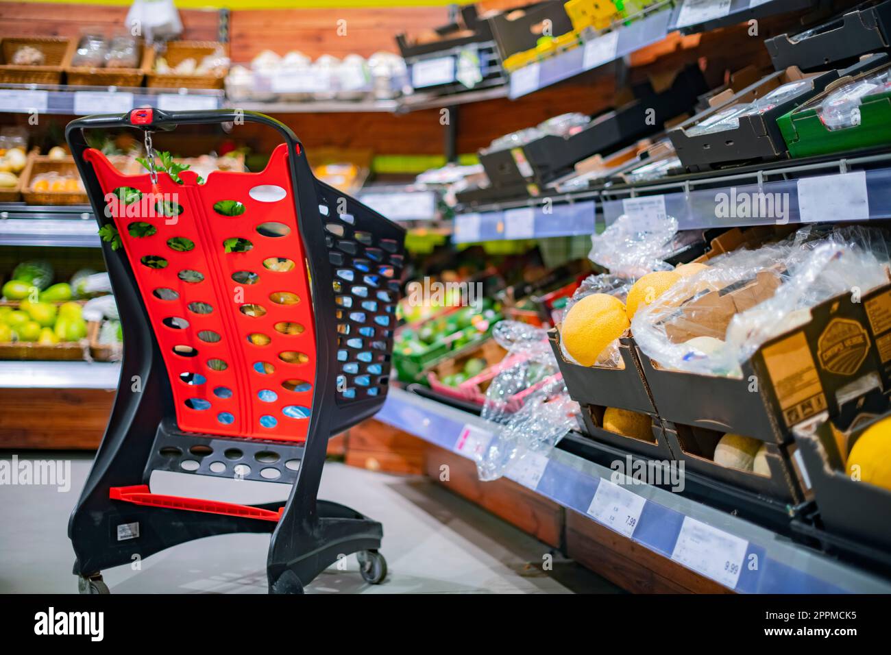 A shopping cart with grocery products in a supermarket Stock Photo - Alamy