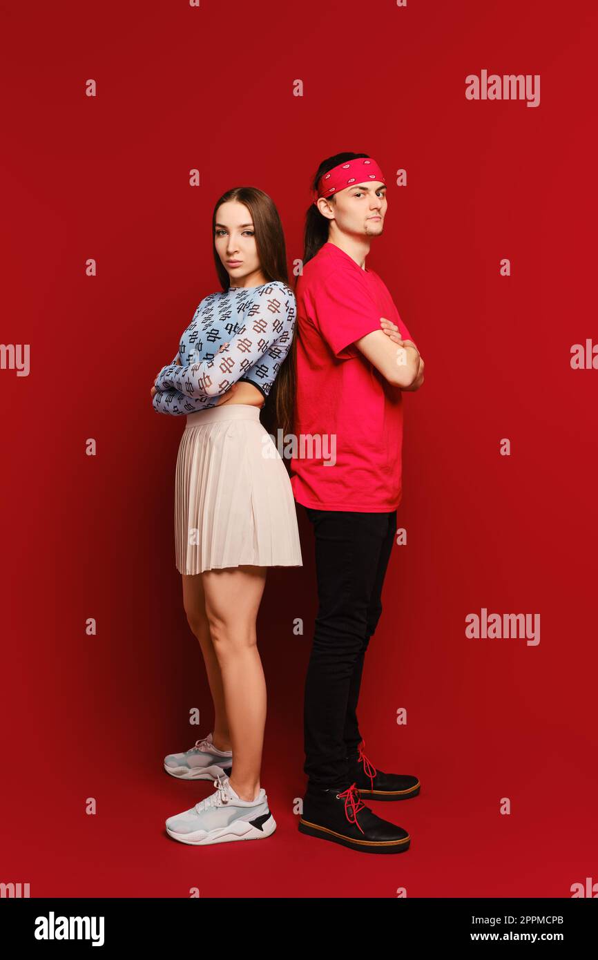 Sporty man and woman stand back to back Stock Photo - Alamy