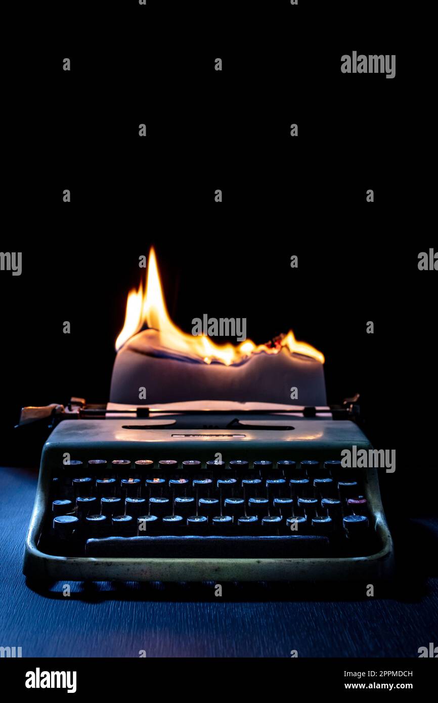 typewriter and sheet of paper catching fire Stock Photo - Alamy