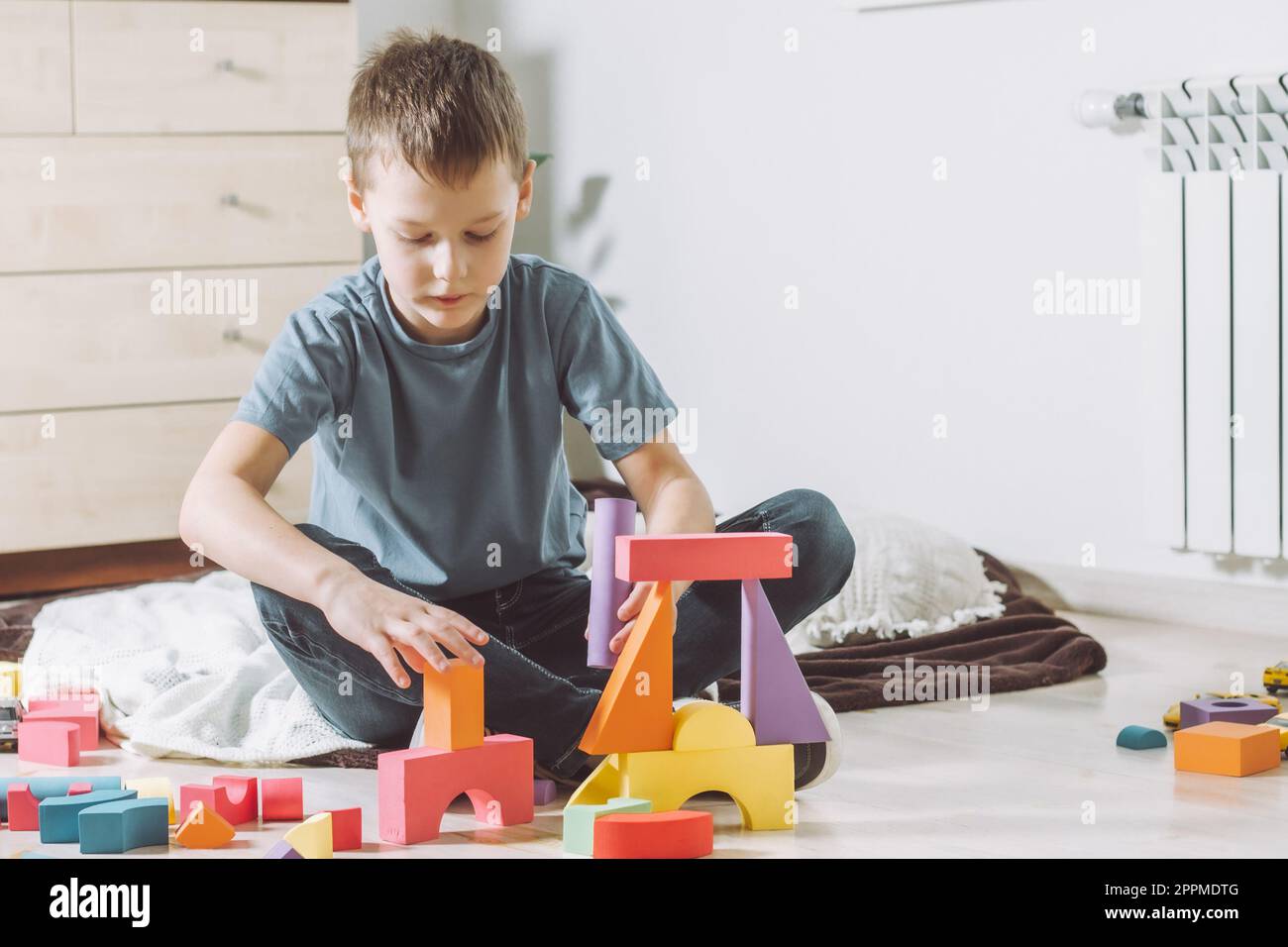 Boy playing with wooden blocks hi-res stock photography and images - Alamy
