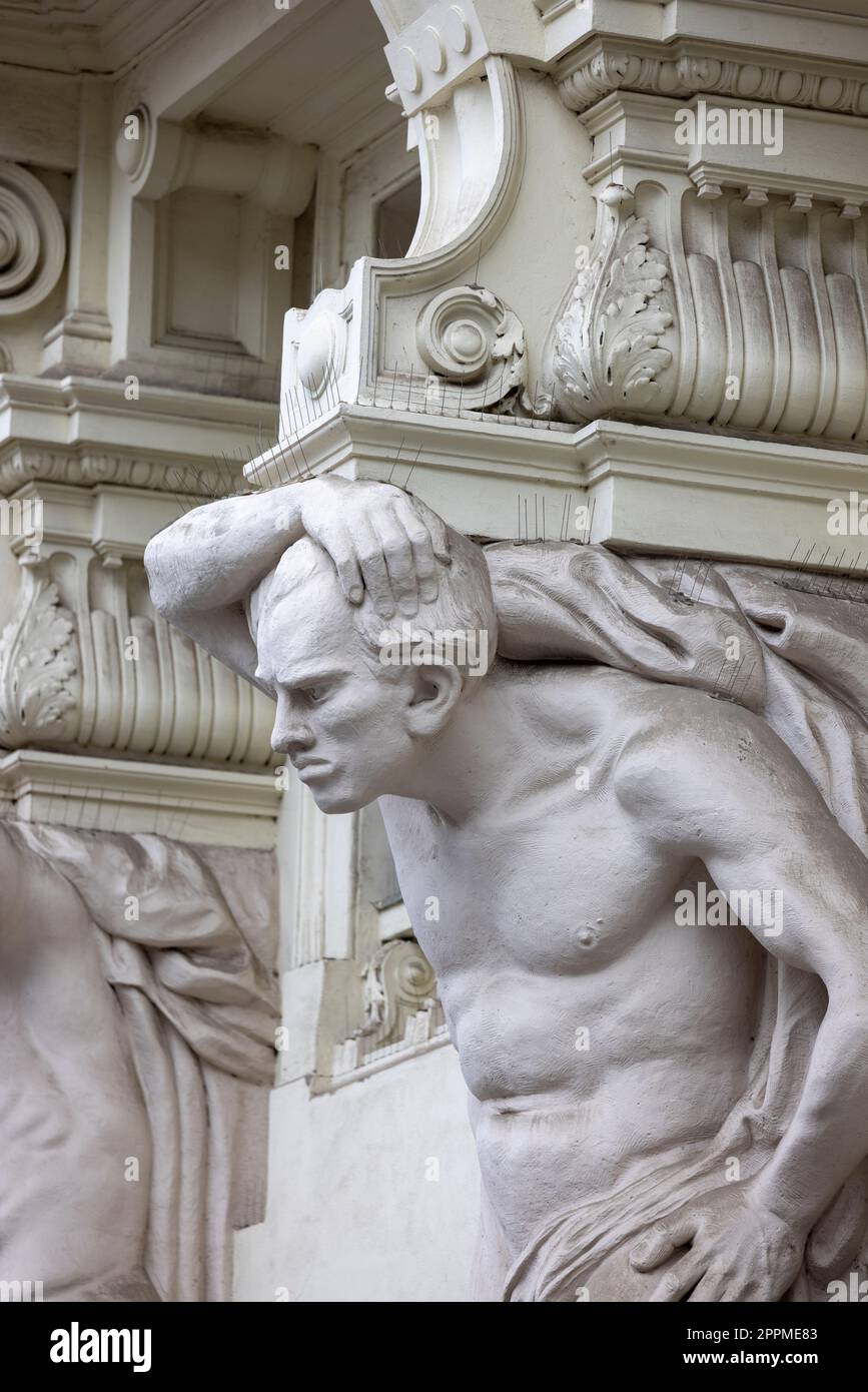 House of the Four Giants with figures of four men on Freedom Square ...