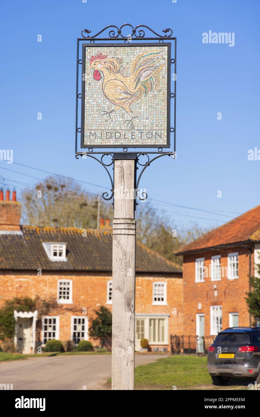 Traditional village sign on a wooden post in the centre of Middleton ...
