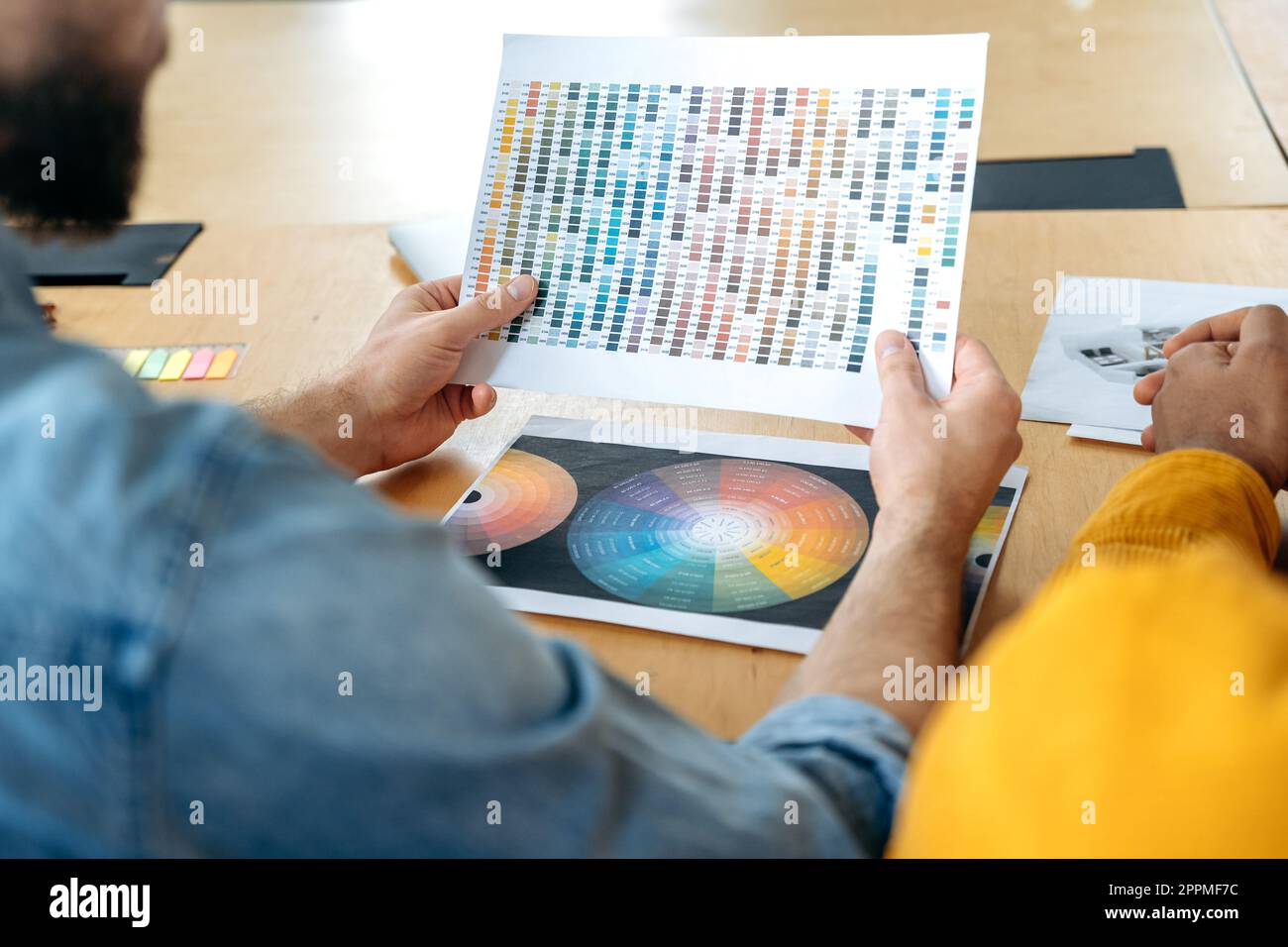 Working on a design project. Pantone color palette over the shoulders ...