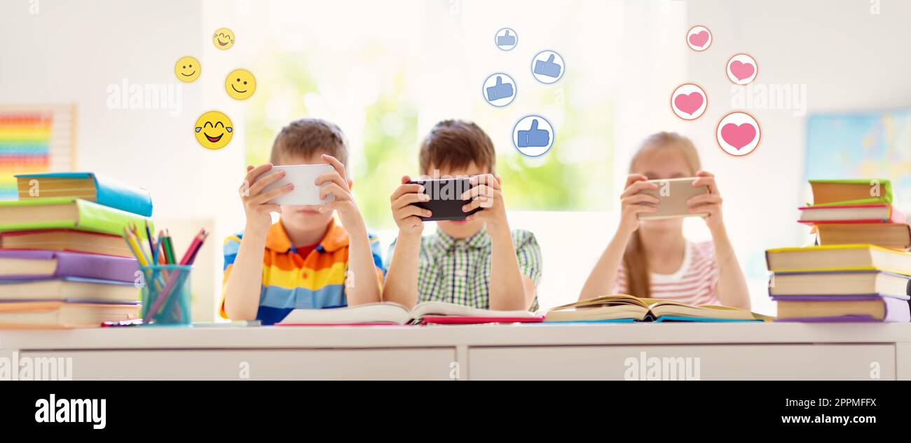 Children sitting in the room with smart phones Stock Photo - Alamy