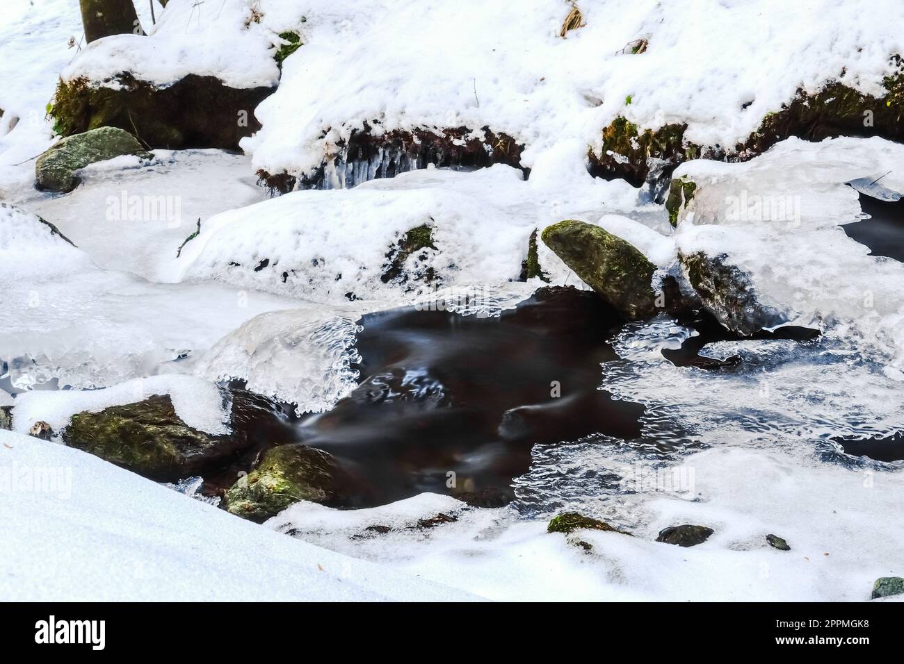frozen brook with ice and snow Stock Photo - Alamy