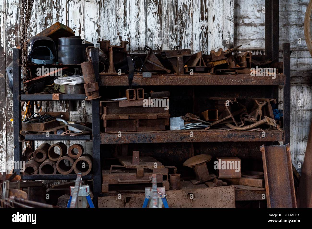 Shelf with rusty iron and steel parts Stock Photo - Alamy
