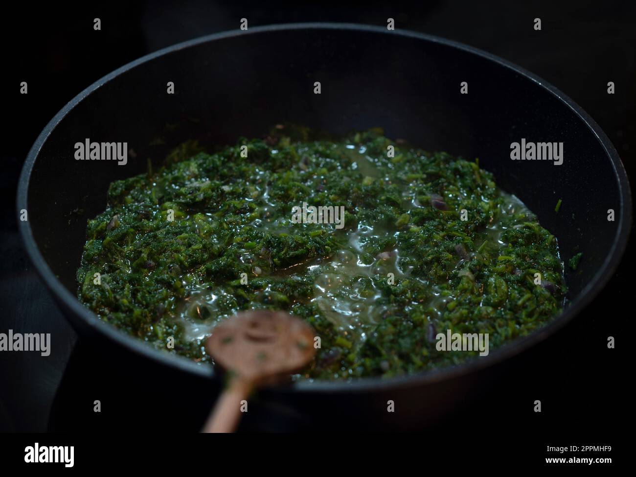 The preparation process of nettles in the pan recipe Stock Photo - Alamy