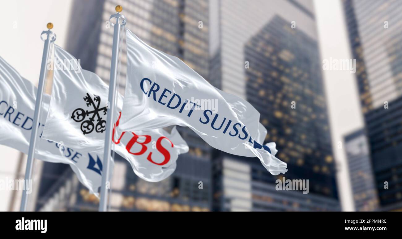 Flags of Credit Suisse and UBS fluttering in the wind in a financial ...