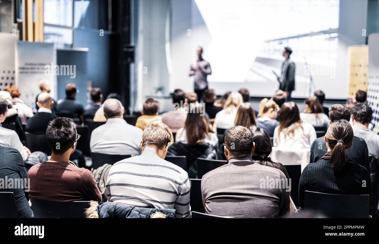 Speaker giving a talk in conference hall at business event. Audience at ...