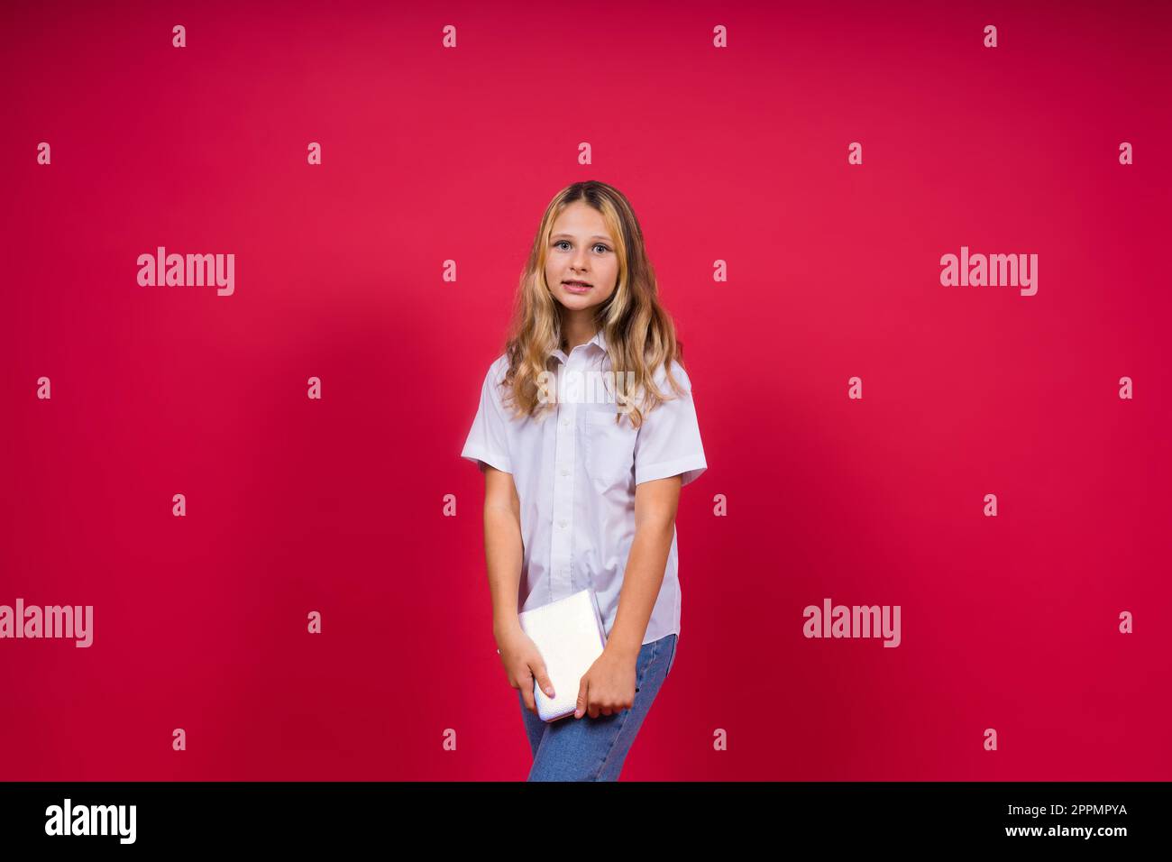 Child making notes. Kids dreams.Isolated on red background. Education ...