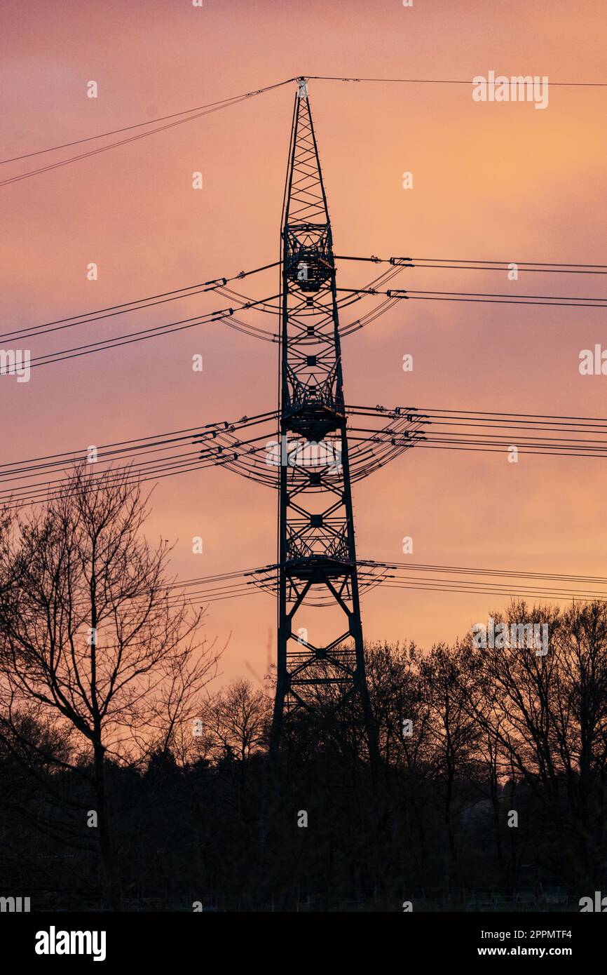 Utility pole during a magnificent sunset electricity Stock Photo - Alamy