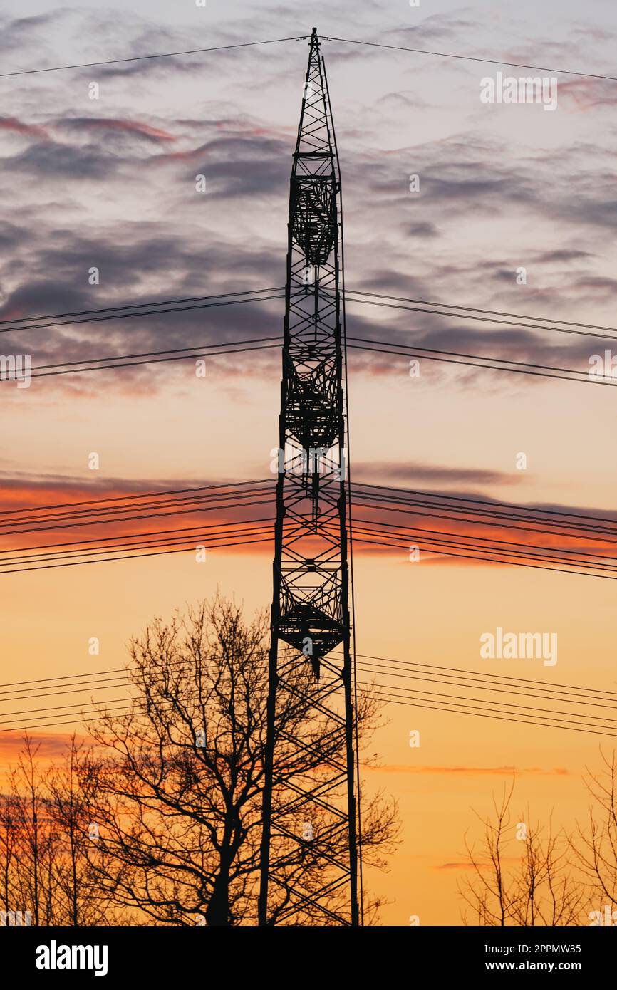 Utility pole during a magnificent sunset electricity Stock Photo - Alamy