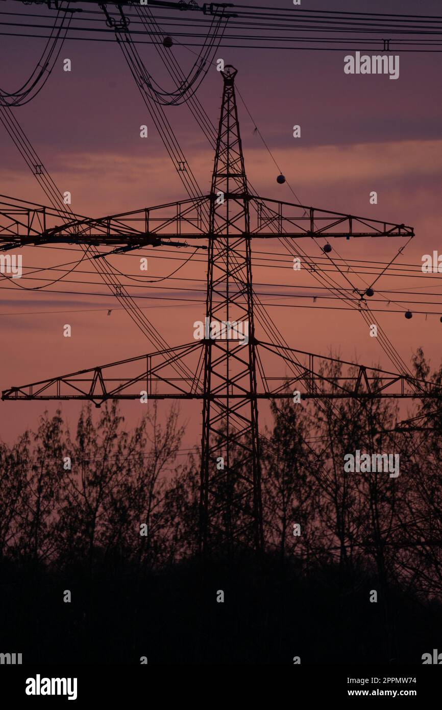 Utility pole during a magnificent sunset electricity Stock Photo - Alamy