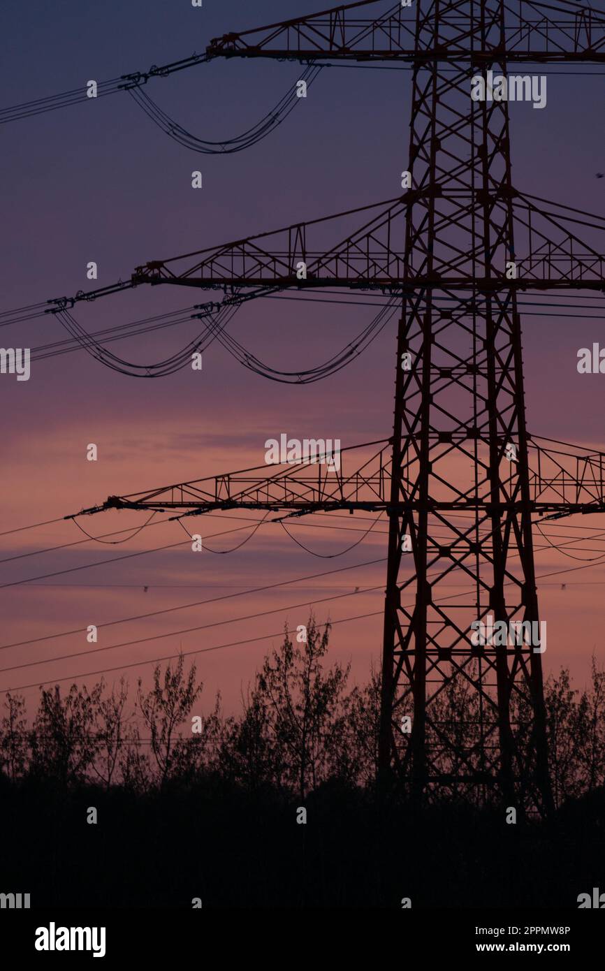 Utility pole during a magnificent sunset electricity Stock Photo - Alamy