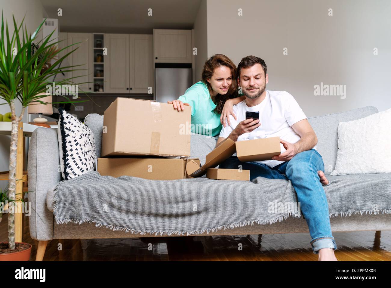 Young couple satisfied consumers leaving feedback and rating delivery ...
