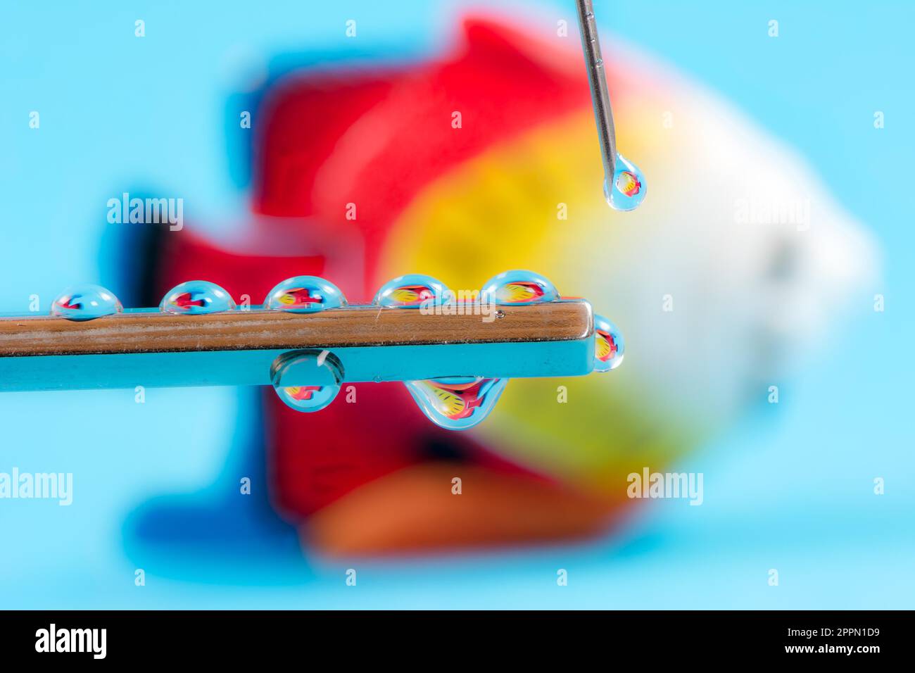 Fish reflections in a drops from a syringe - could be used to ...