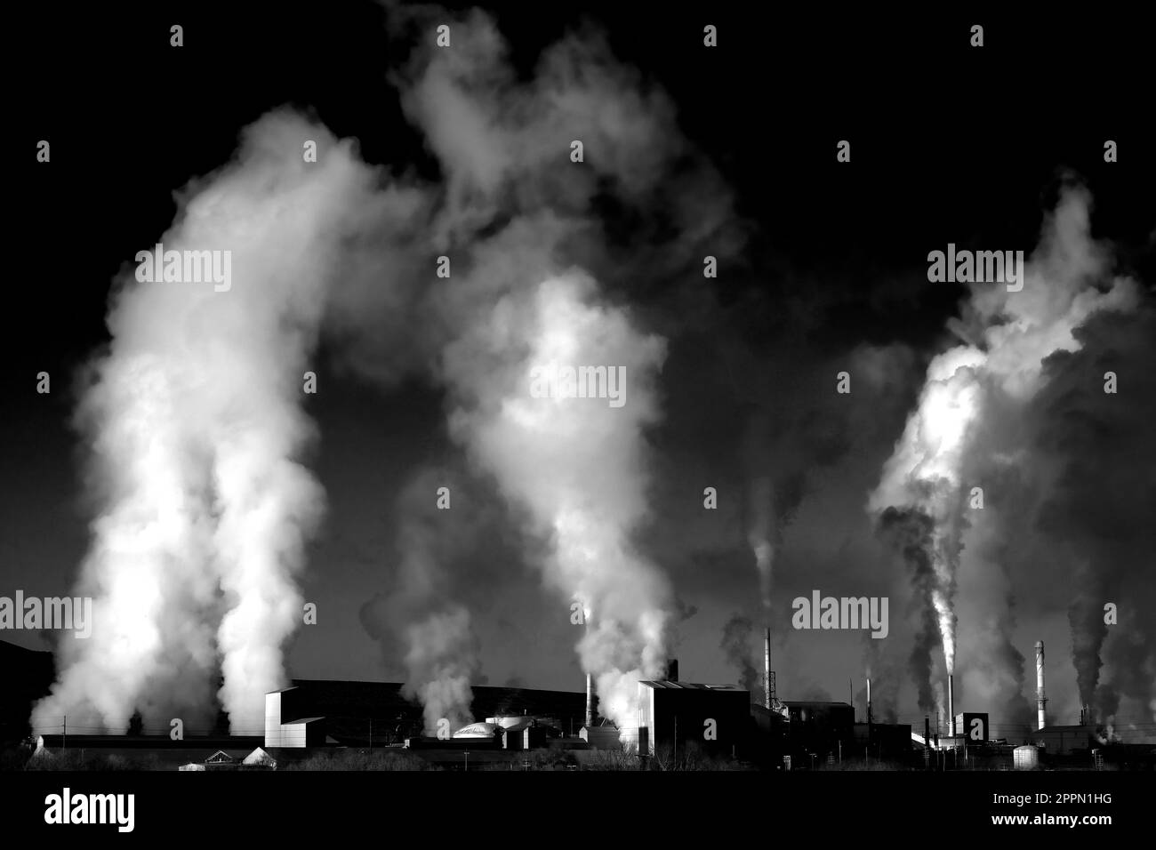 Factory chimneys spewing pollution into the sky smoke rising pollutants ...